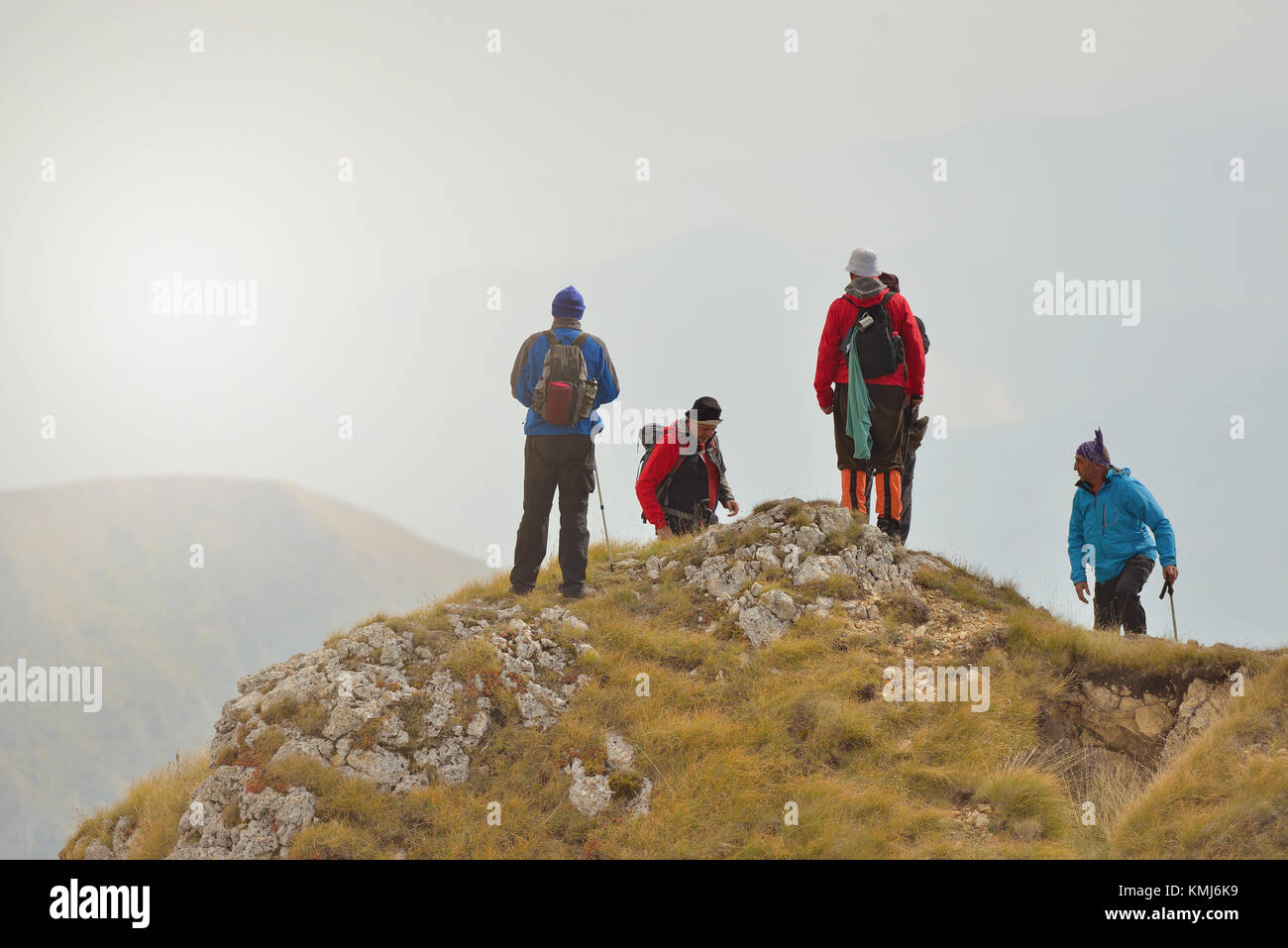 Group of People of different age and ethnicity walking up on Mountain ...