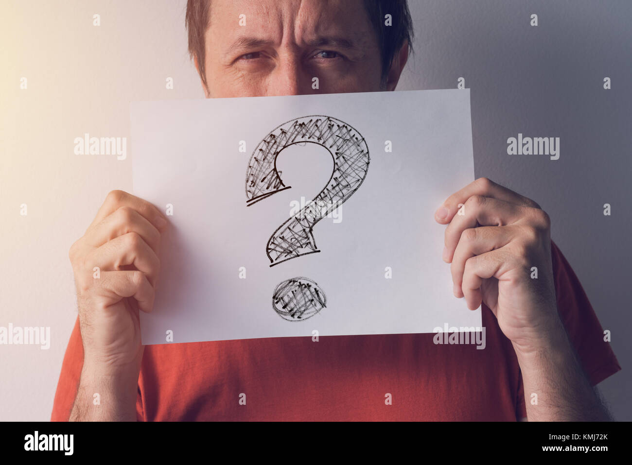 Question mark, looking for answers. Man holding paper with scribbled ...