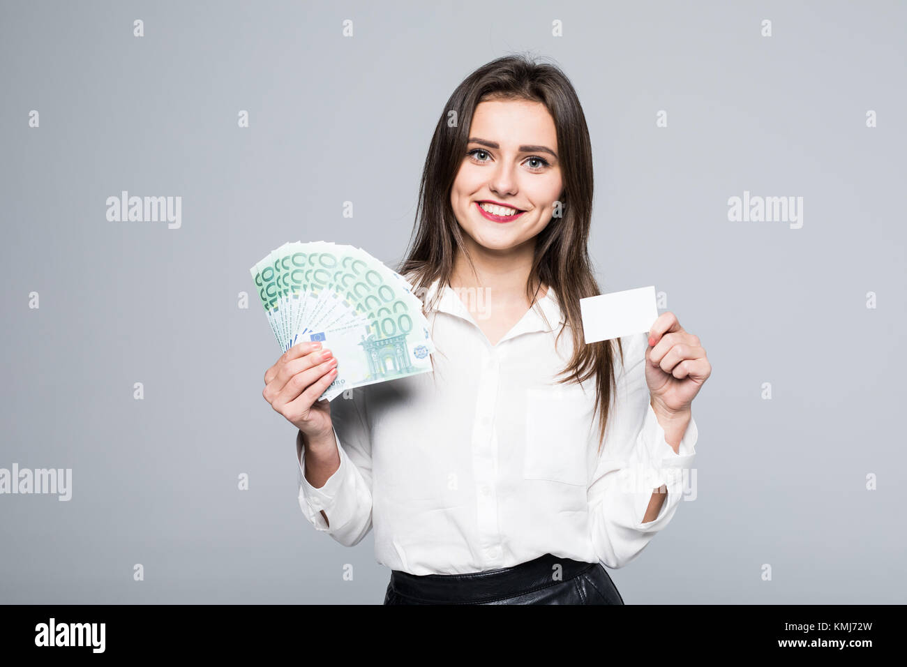 Beauitful woman holding some Euro currency notes, isolated over white ...