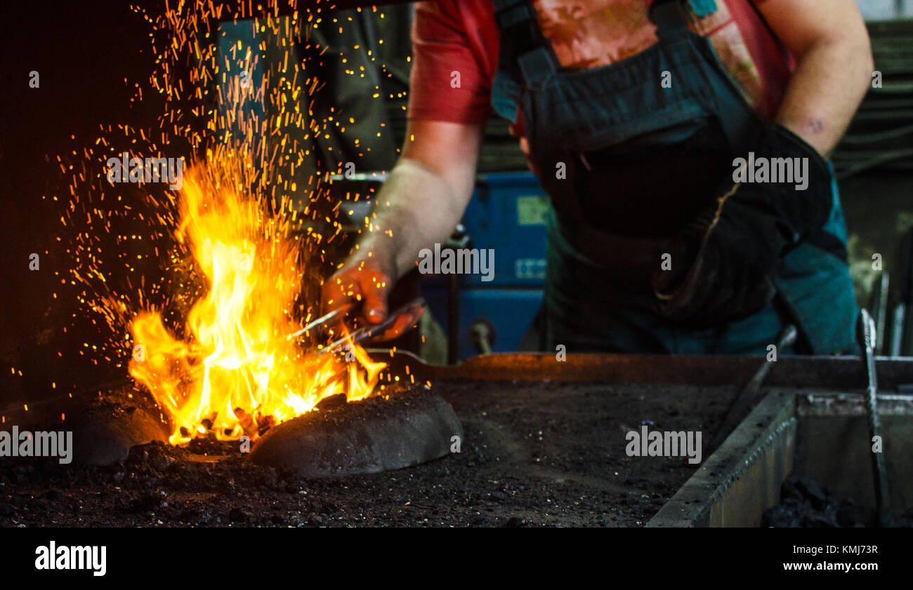Blacksmith at work, hit with a hammer by a hot metal on the anvil Stock ...