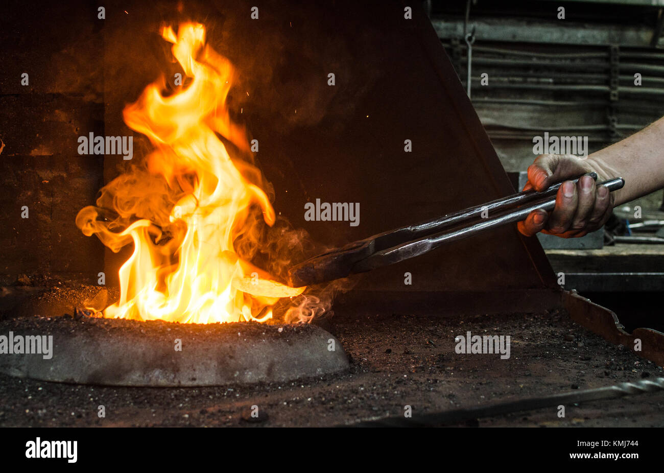 Blacksmith at work, hit with a hammer by a hot metal on the anvil Stock ...