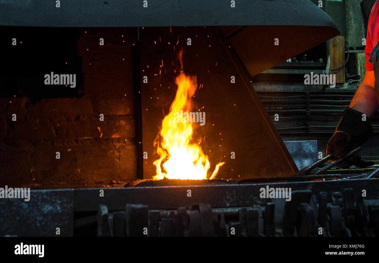 Blacksmith at work, hit with a hammer by a hot metal on the anvil Stock ...