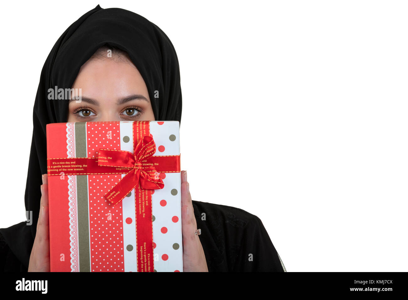 Happy young muslim woman with gift box isolated over white background ...