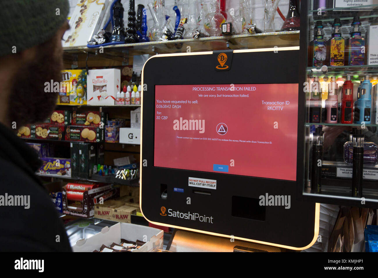 A customer uses a Bitcoin machine in Piccadilly Circus in London, as ...