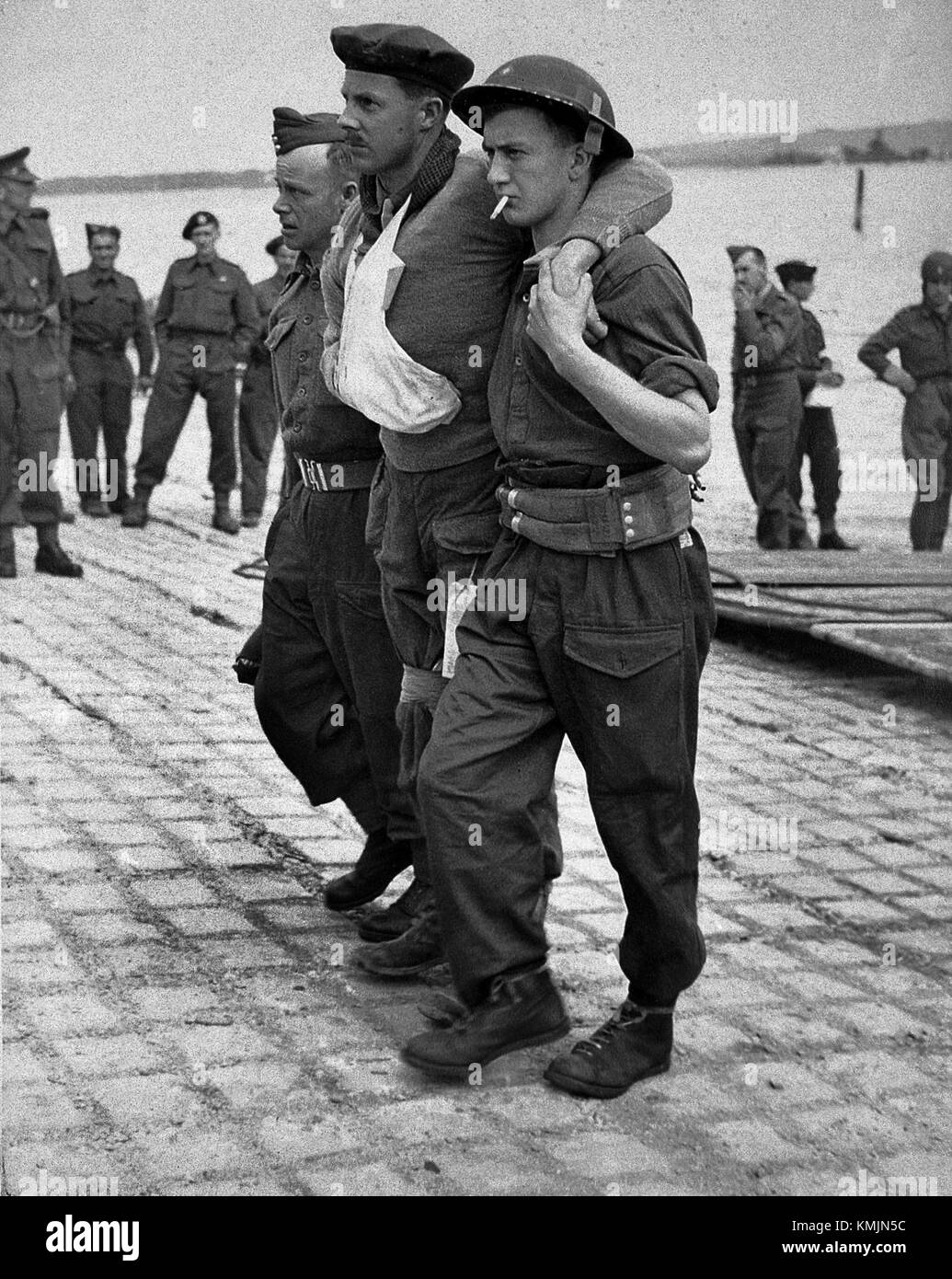 This image depicts a wounded soldier receiving aid during World War I ...