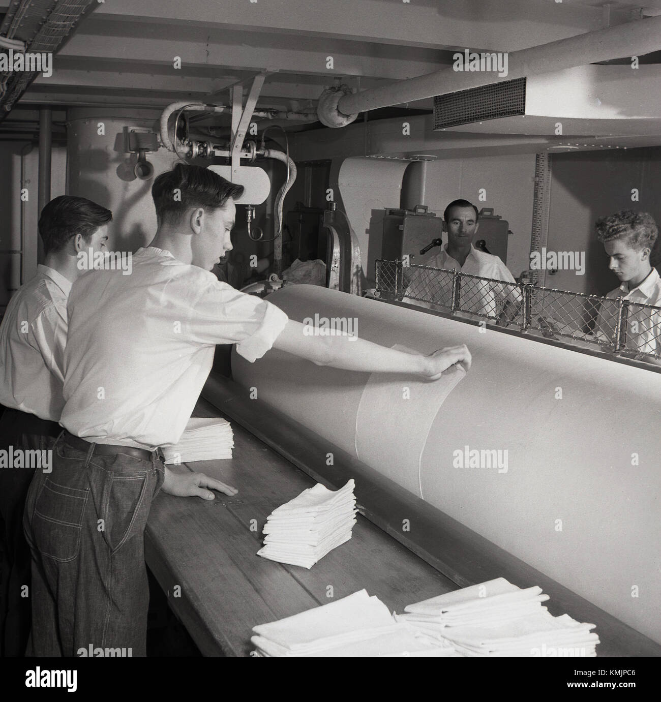 1950s, historical, Young men working in the laundry room below deck on ...