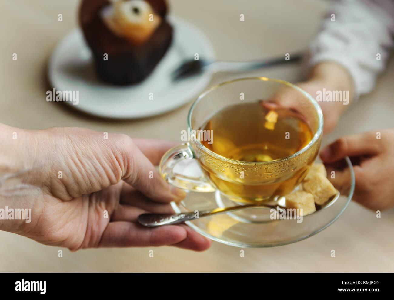 Cup of tea in the children's hands. The child takes the cup from the ...