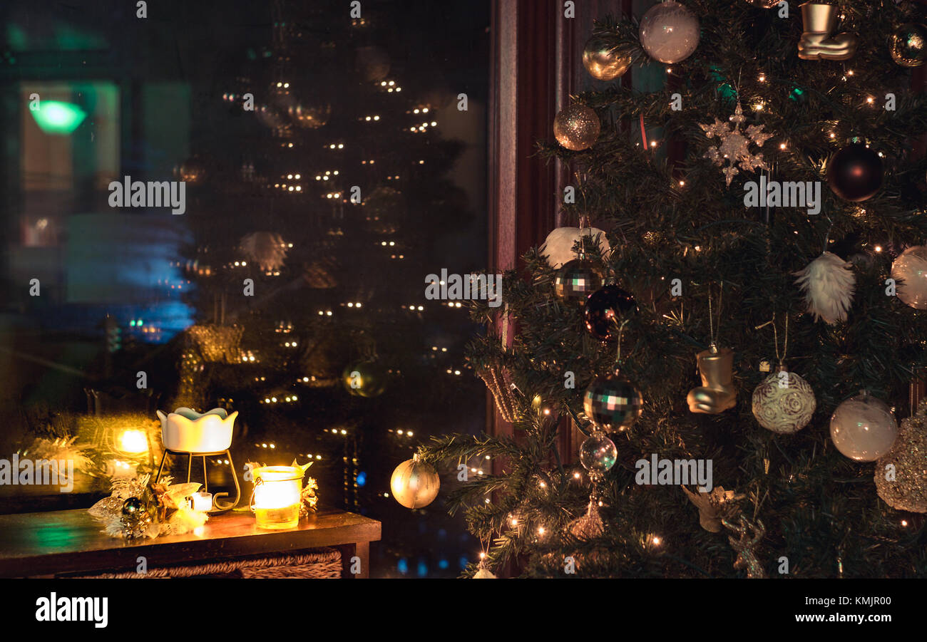 Christmas tree with baubles, trinkets and lights, in golden colours ...