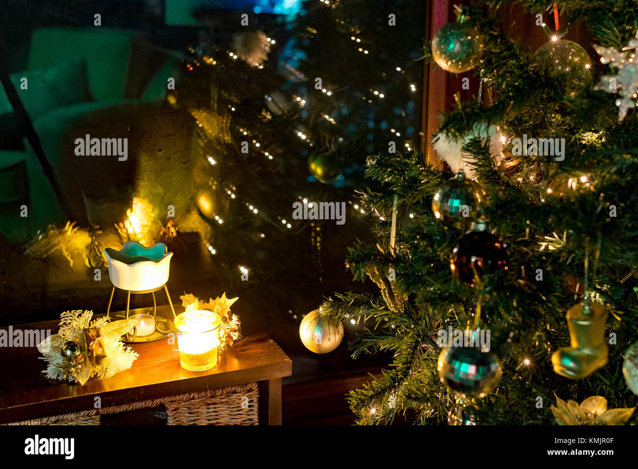 Christmas tree with baubles, trinkets and lights, in golden colours ...