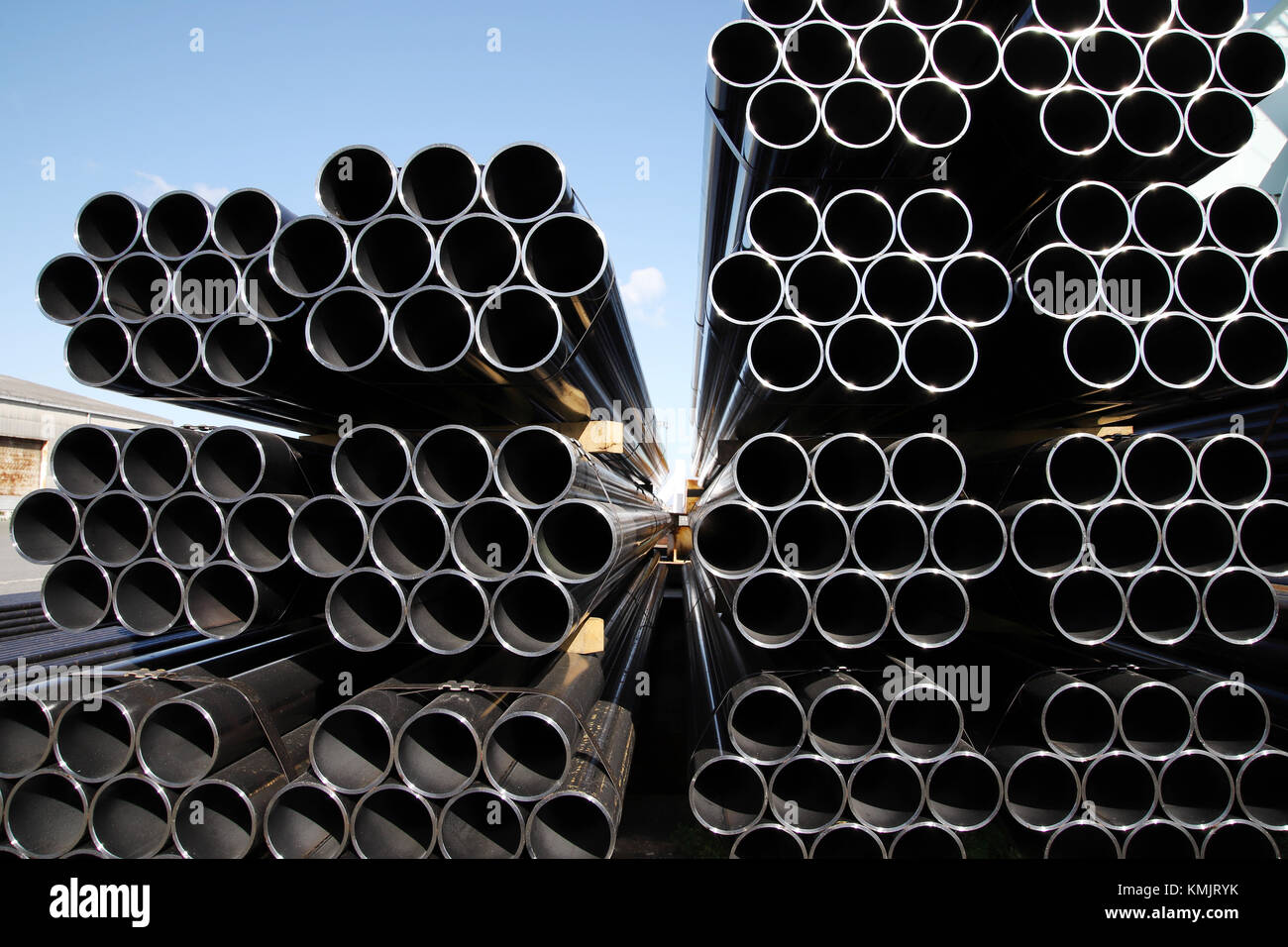 stack of steel tubes industrial against clear blue sky Stock Photo - Alamy