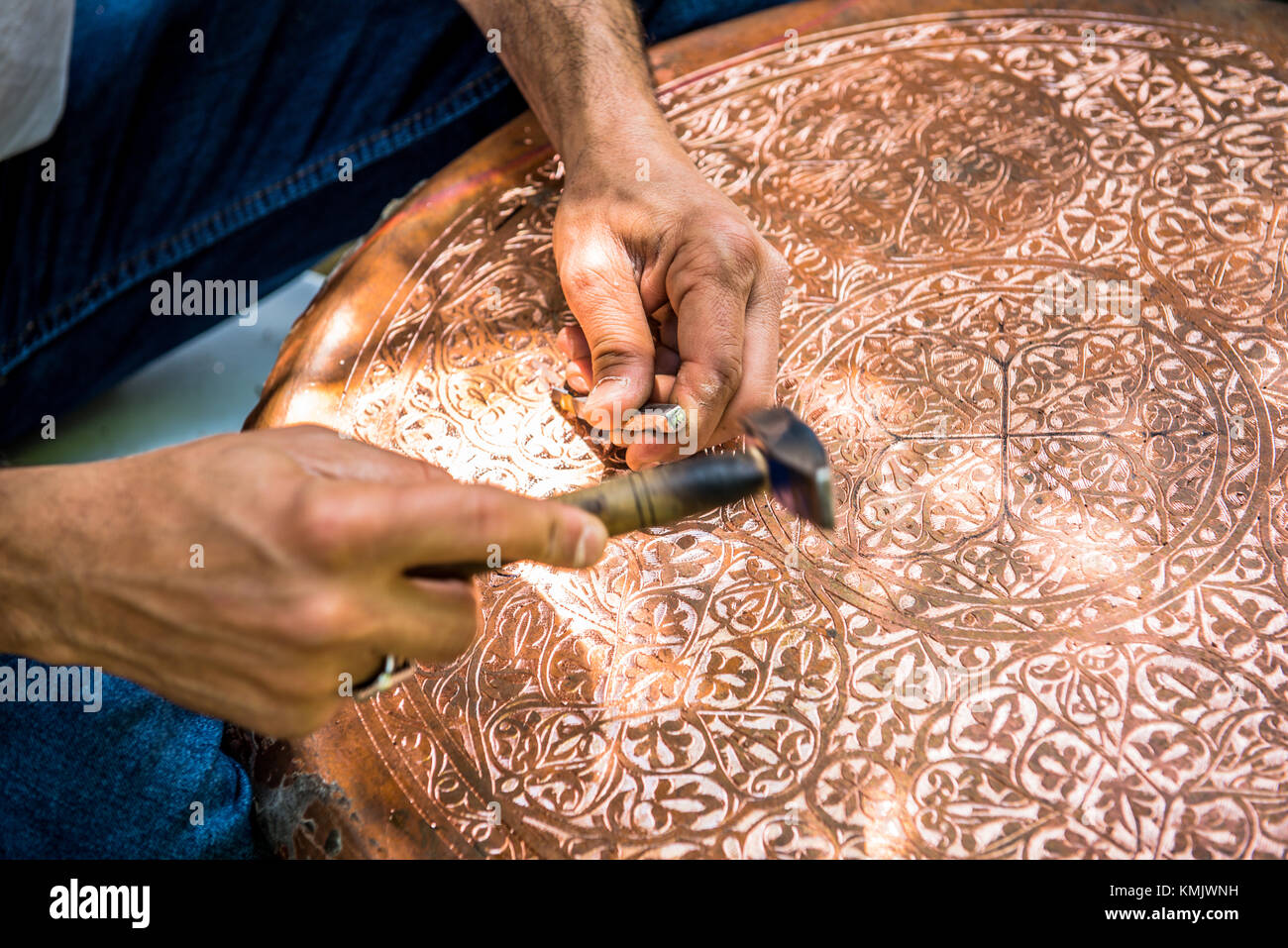 Senior craftsman,tinsmith,working with hammer during hand stamping or ...