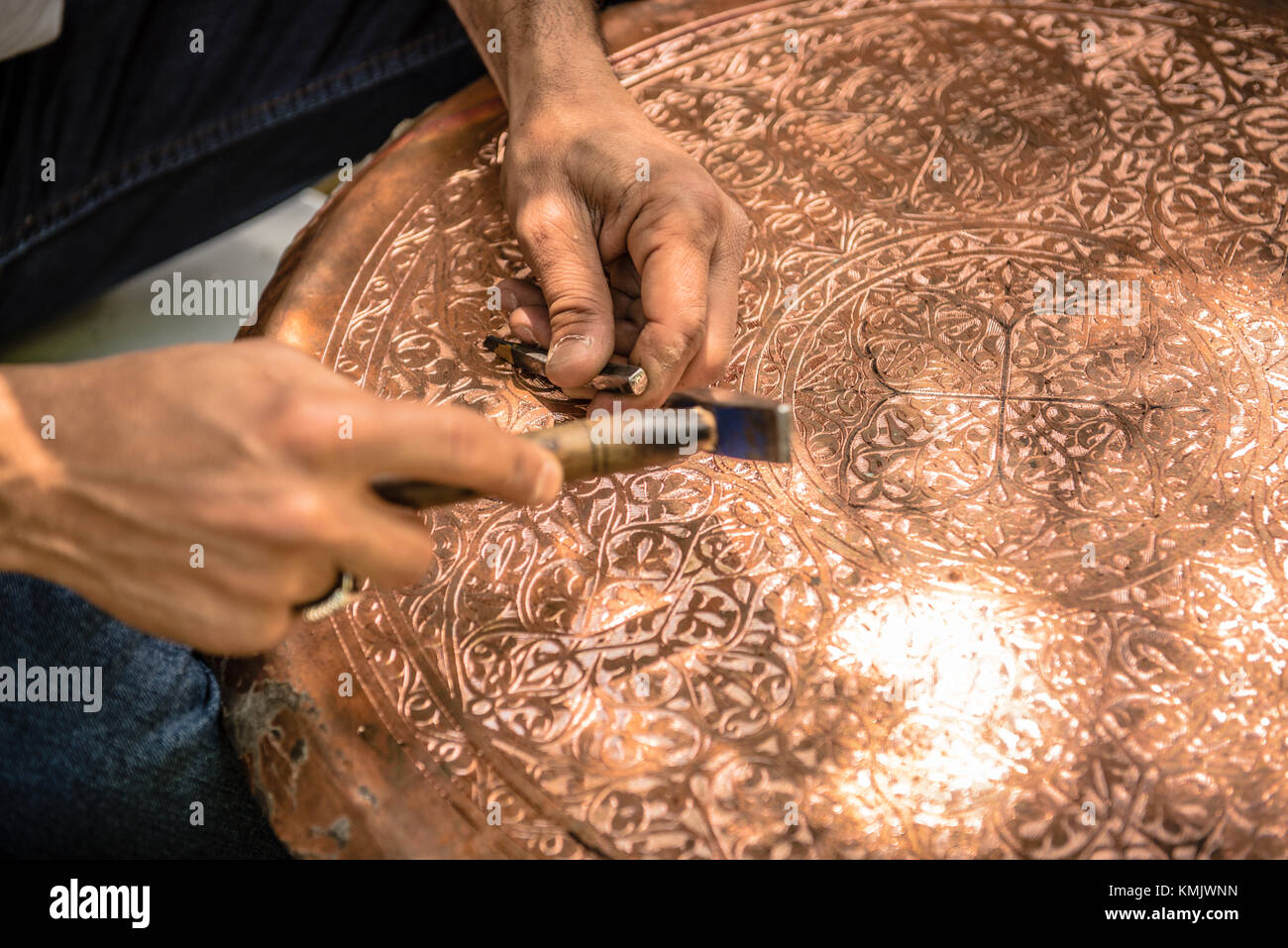 Senior craftsman,tinsmith,working with hammer during hand stamping or ...
