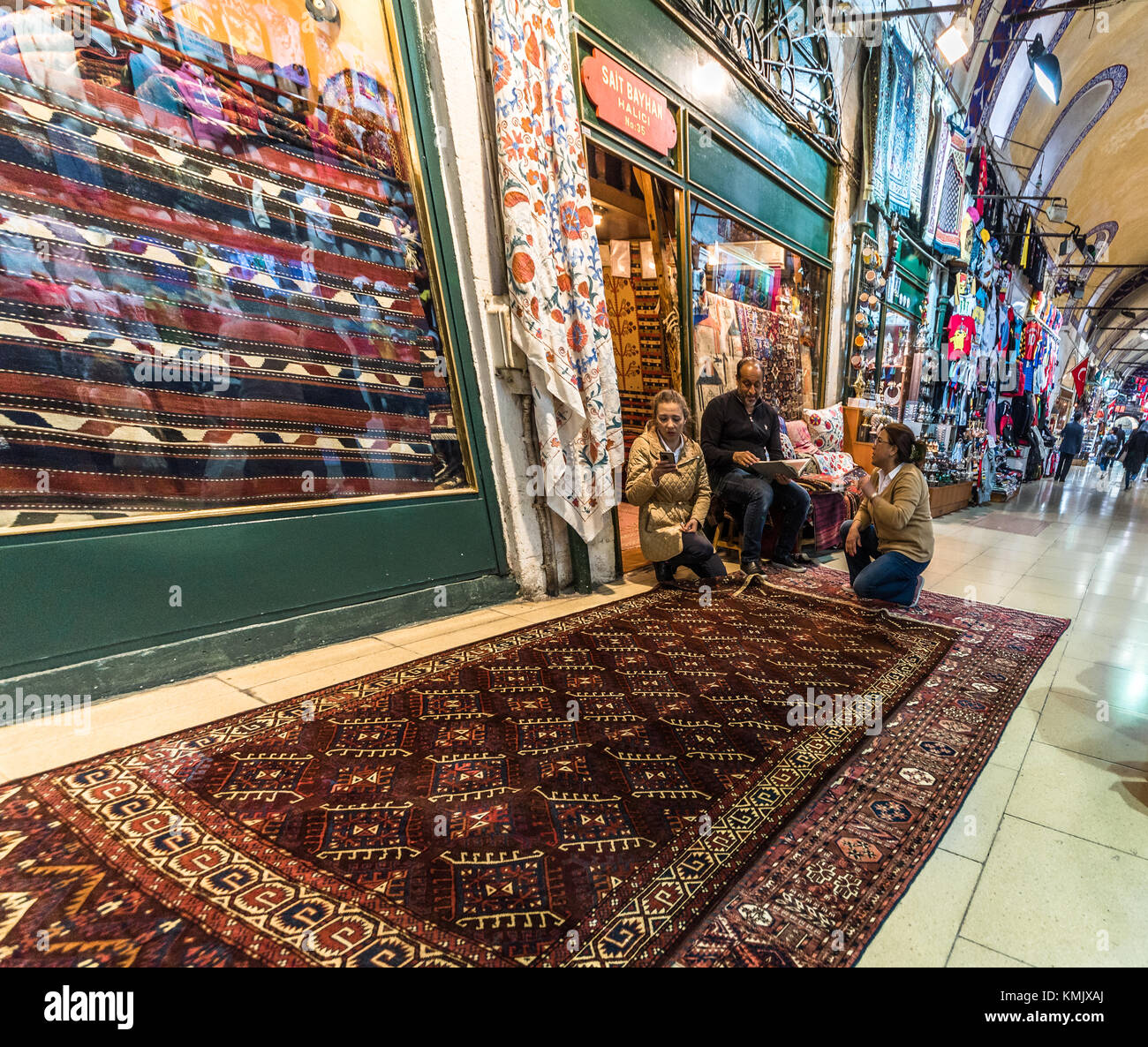 Unidentified Tourists shopping rugs and carpets in the Grand Bazaar in ...