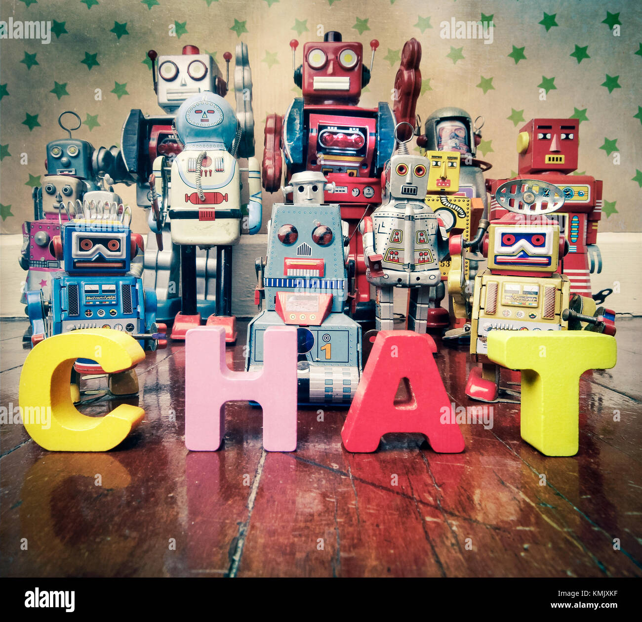 Chat Bot with wooden letters with retro robot toys on old woden floor ...