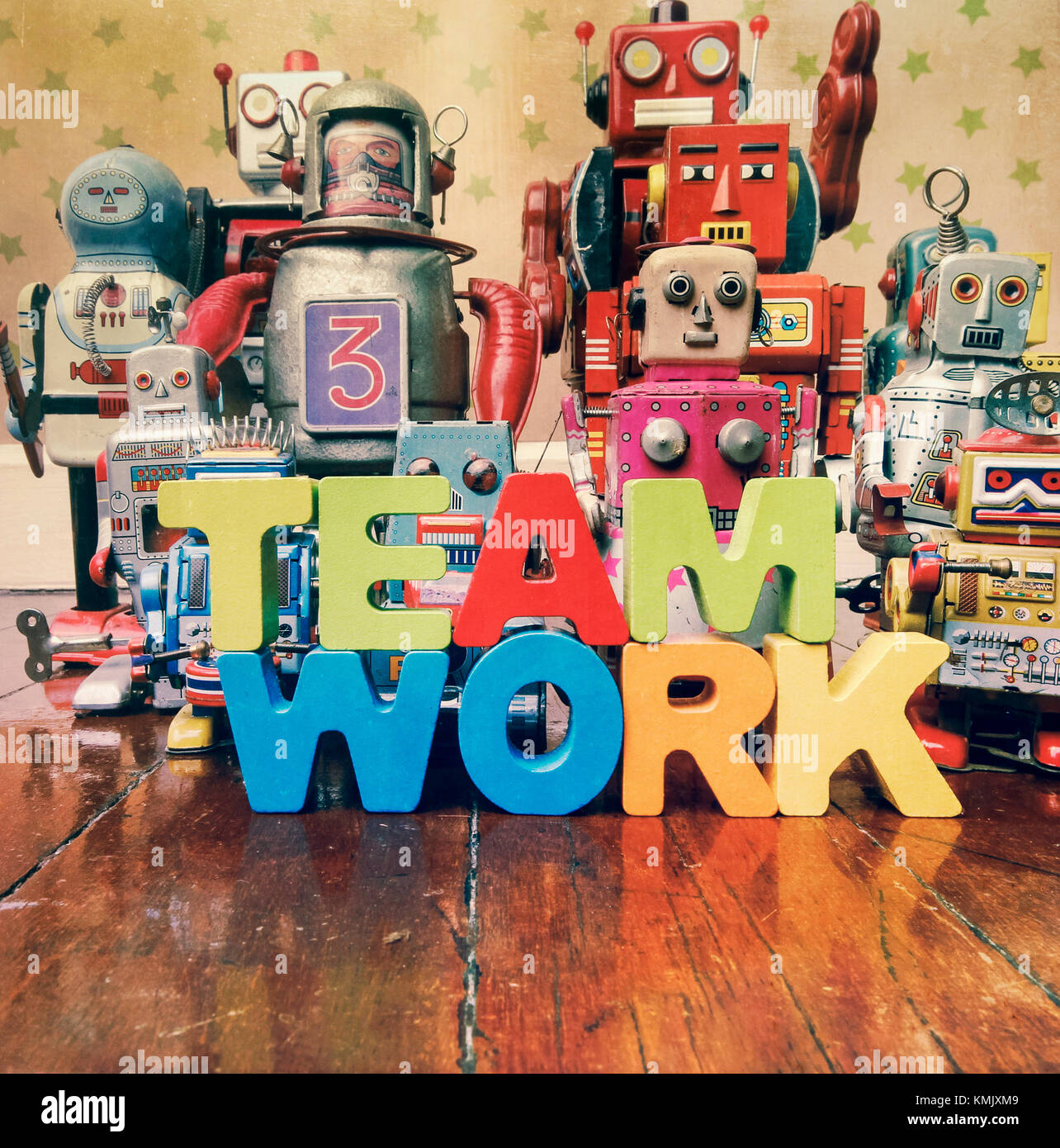 Concept TEAM WORK with wooden letters and vintage robot toys on a old ...