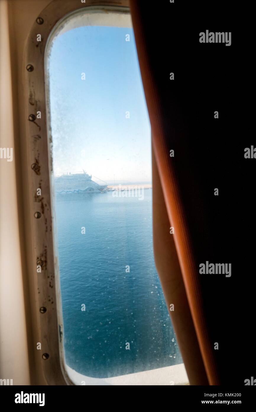 Sunrise seen from behind a ferry boat window. Mediterranean Coast ...