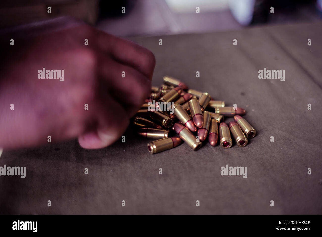Soldier loading a 9mm caliber cartridge on a military shooting range ...