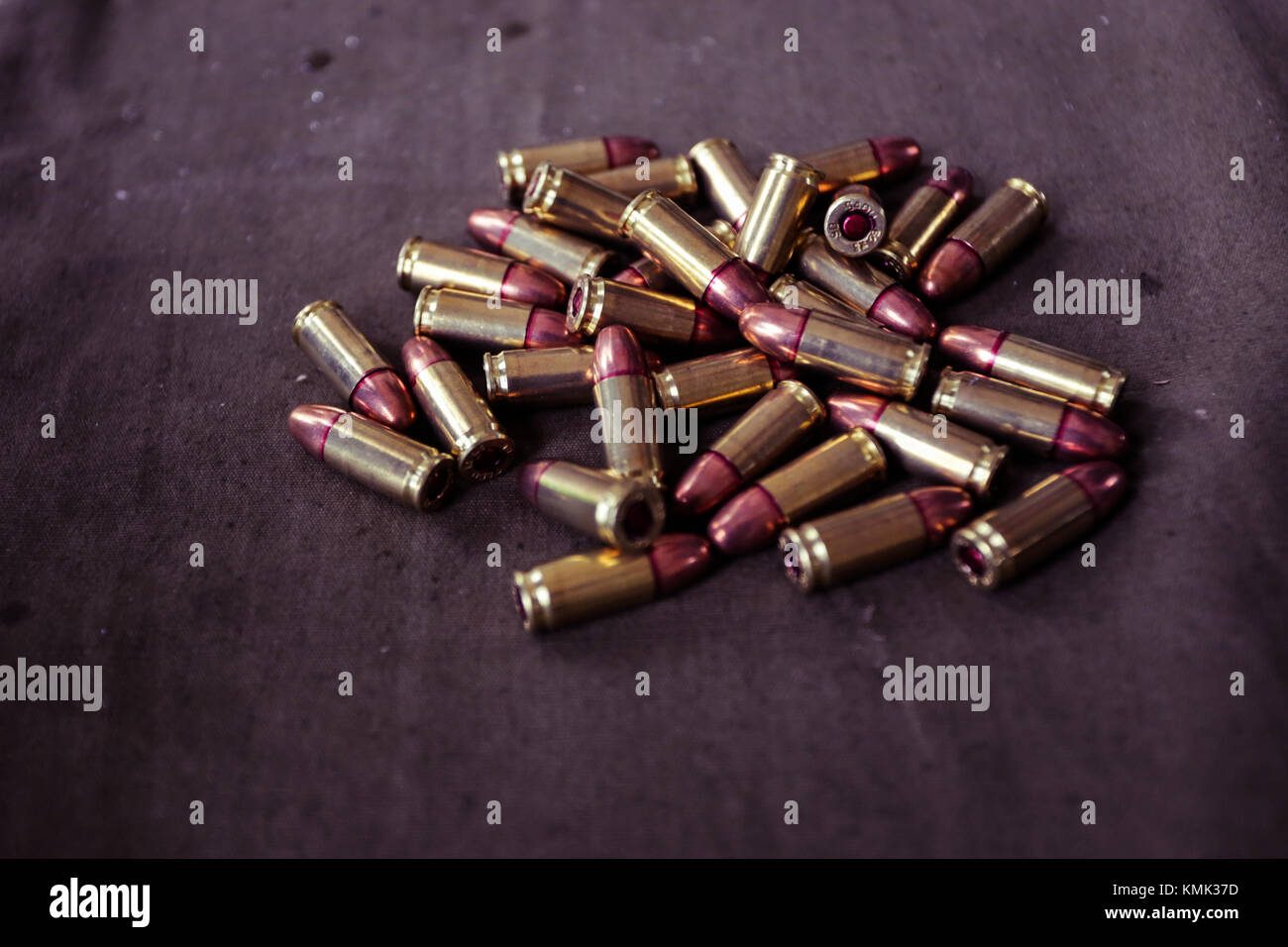 Soldier loading a 9mm caliber cartridge on a military shooting range ...