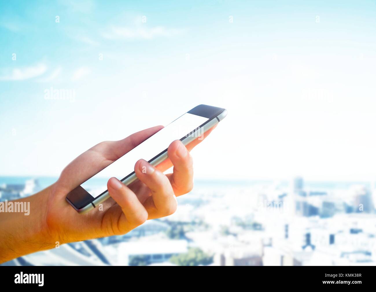 Digital composite of Hand holding phone in city Stock Photo - Alamy