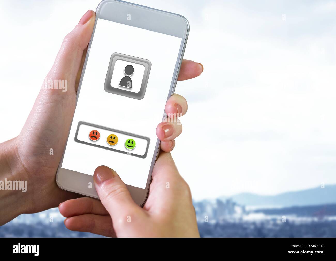 Digital composite of Hand holding phone and Feedback smiley ...