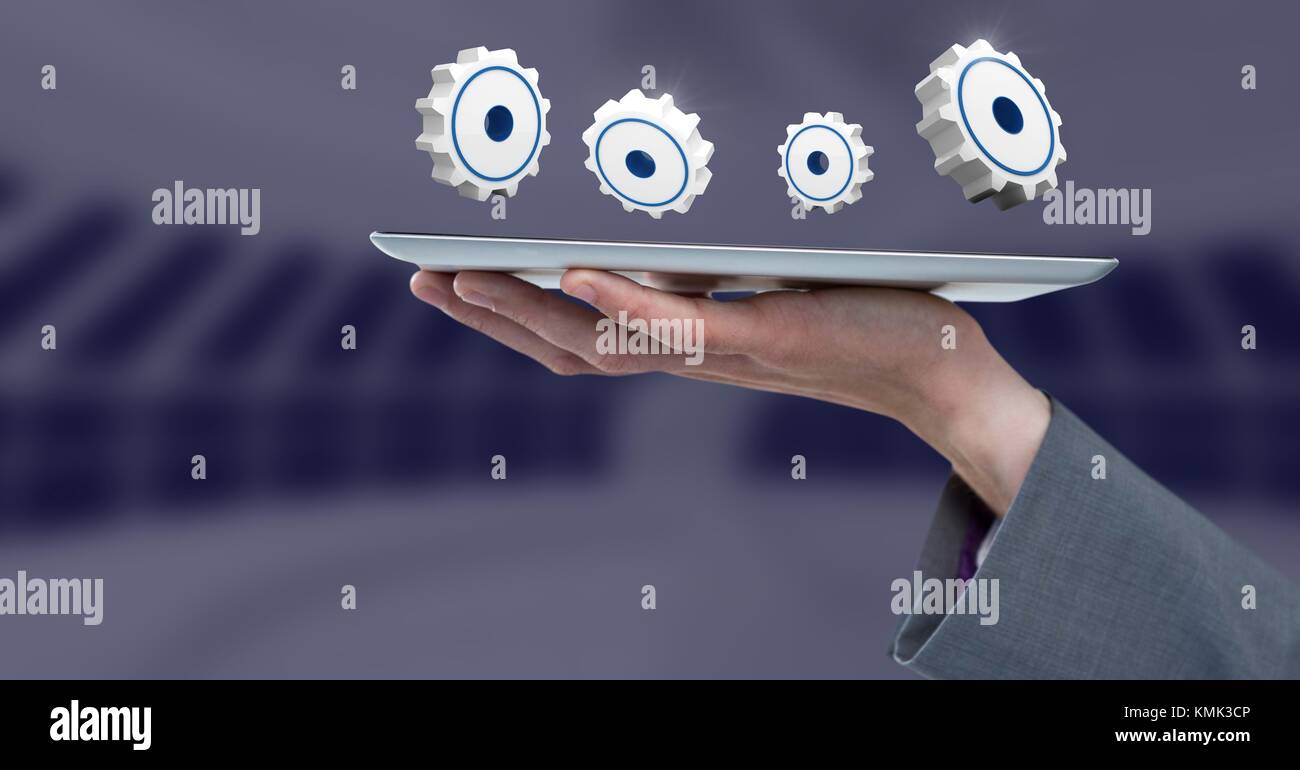Digital composite of Hand holding tablet with 3D cog icons Stock Photo ...