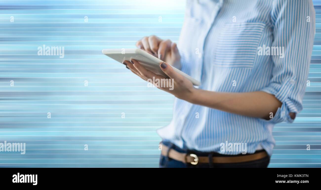 Digital composite of Hand holding tablet with motion blur background ...