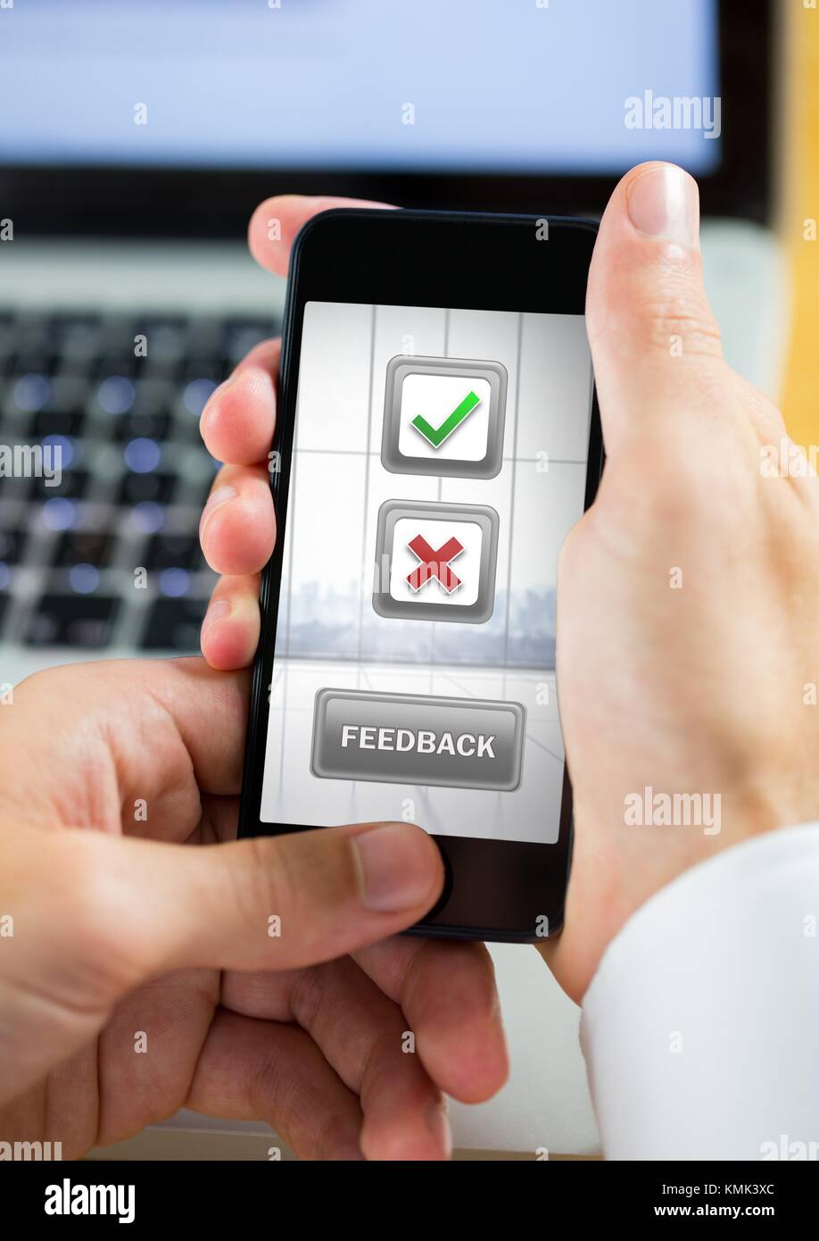 Digital composite of Hand holding phone with feedback buttons Stock ...
