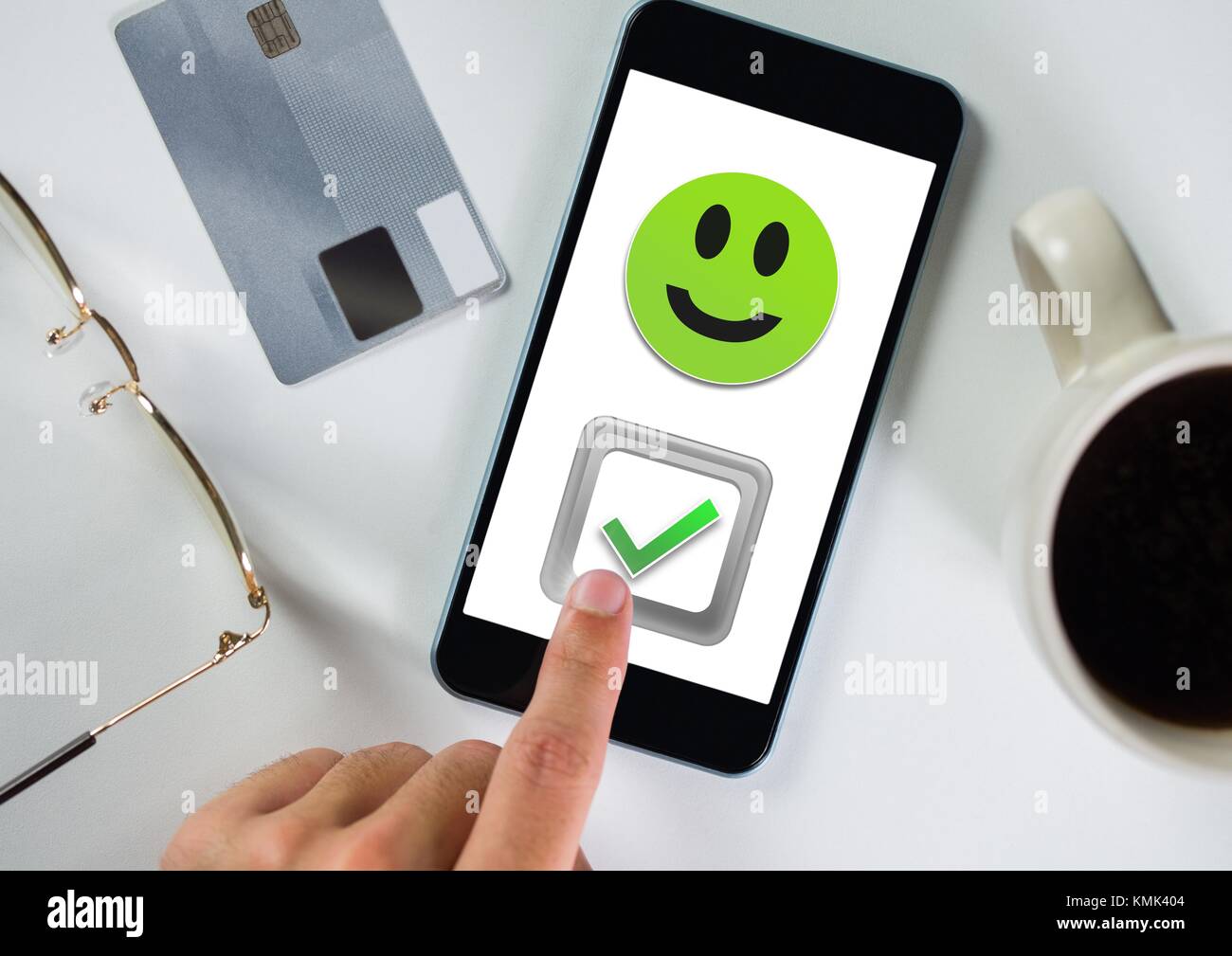 Digital composite of Hand touching correct tick and smiley face on ...