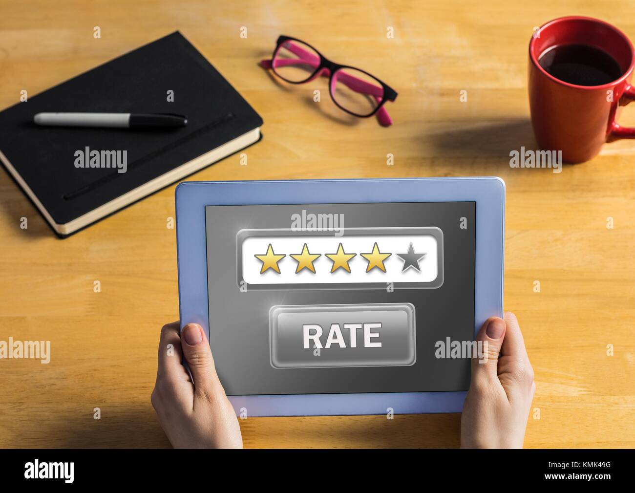 Digital composite of Hands holding tablet with rate button and star ...