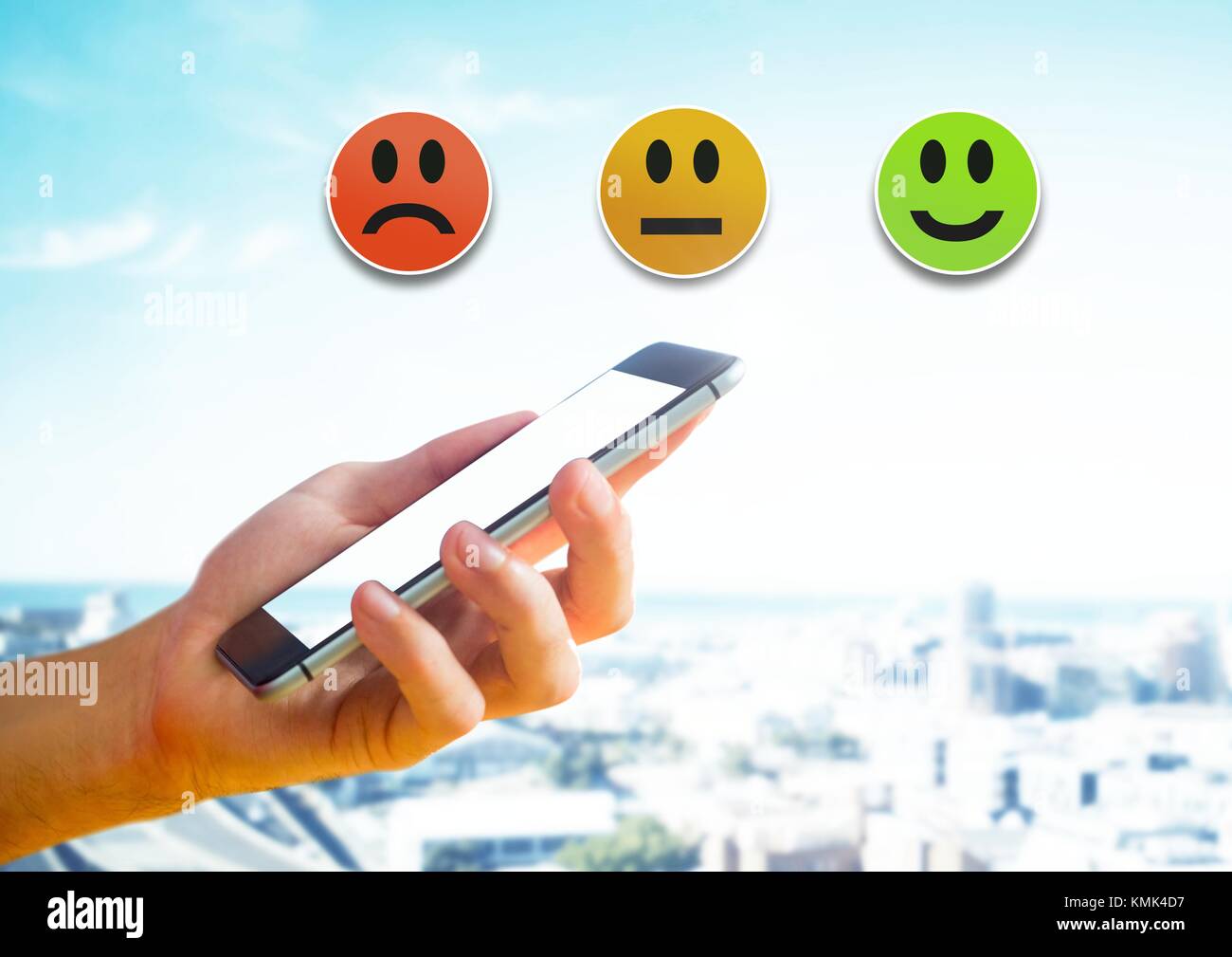 Digital composite of Hand holding phone and Feedback smiley ...