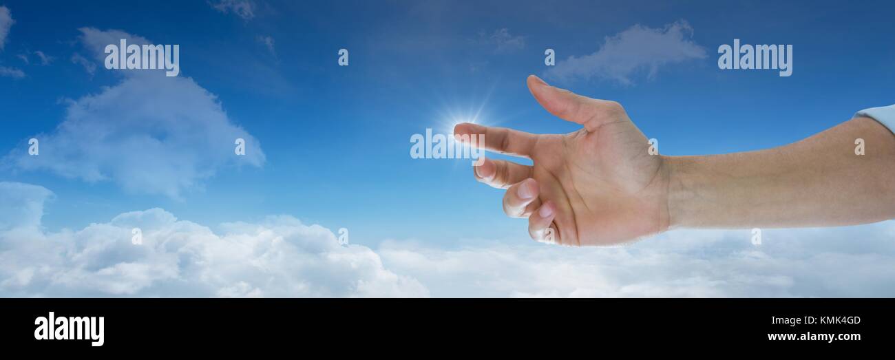 Digital composite of Hand touching sky Stock Photo - Alamy