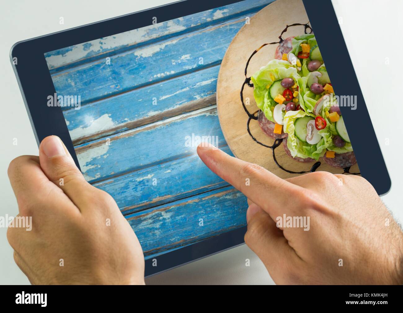 Digital composite of Hand touching tablet with food Stock Photo - Alamy
