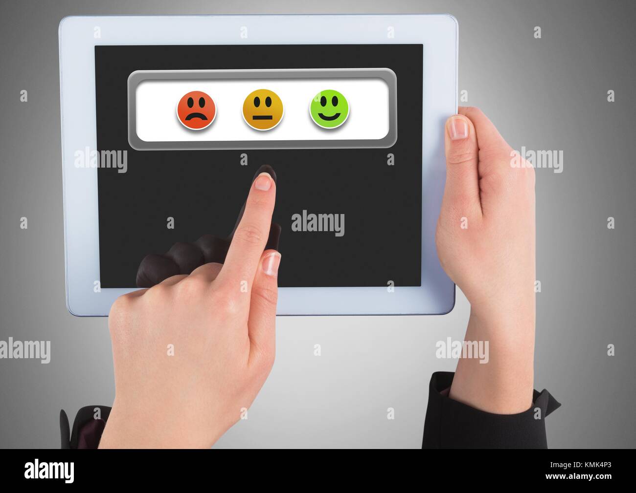 Digital composite of Hands holding tablet with feedback smiley ...