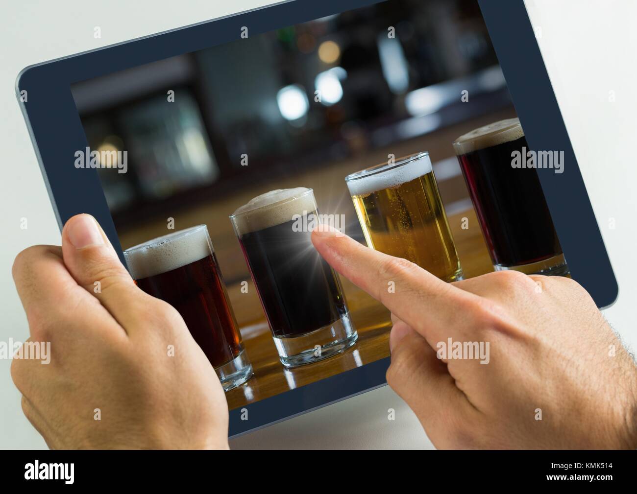 Digital composite of Hand touching tablet with beers selection in bar ...