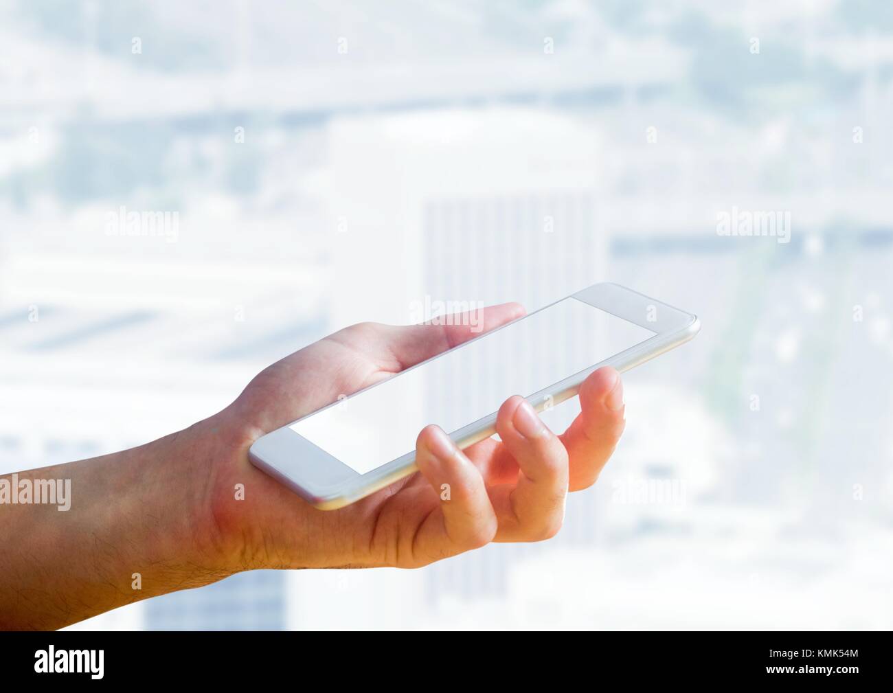 Digital composite of Hand holding phone and city Stock Photo - Alamy