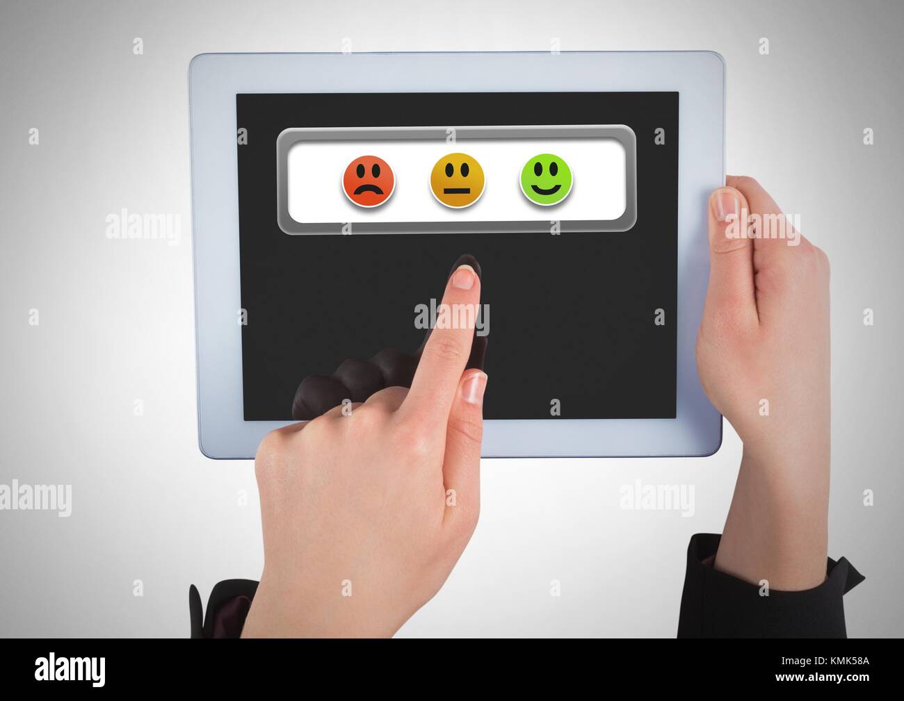 Digital composite of Hand holding tablet with smiley face feedback ...