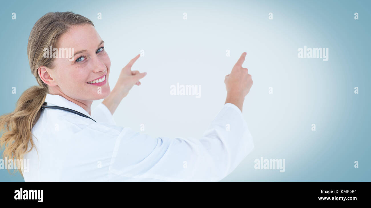 Young doctor pointing on white background Stock Photo - Alamy