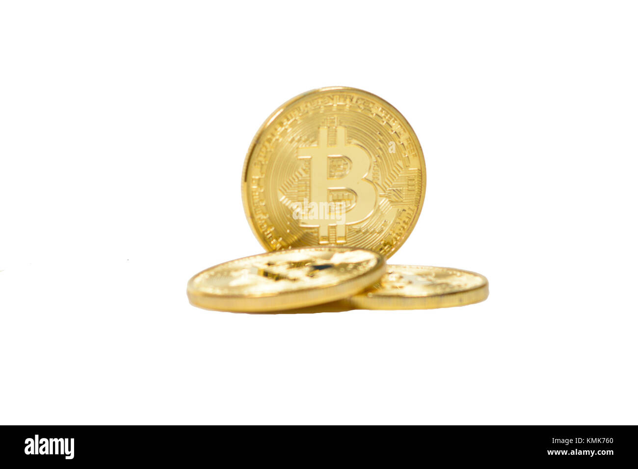 Three yellow metal coins (bitcoin) isolated against white background ...