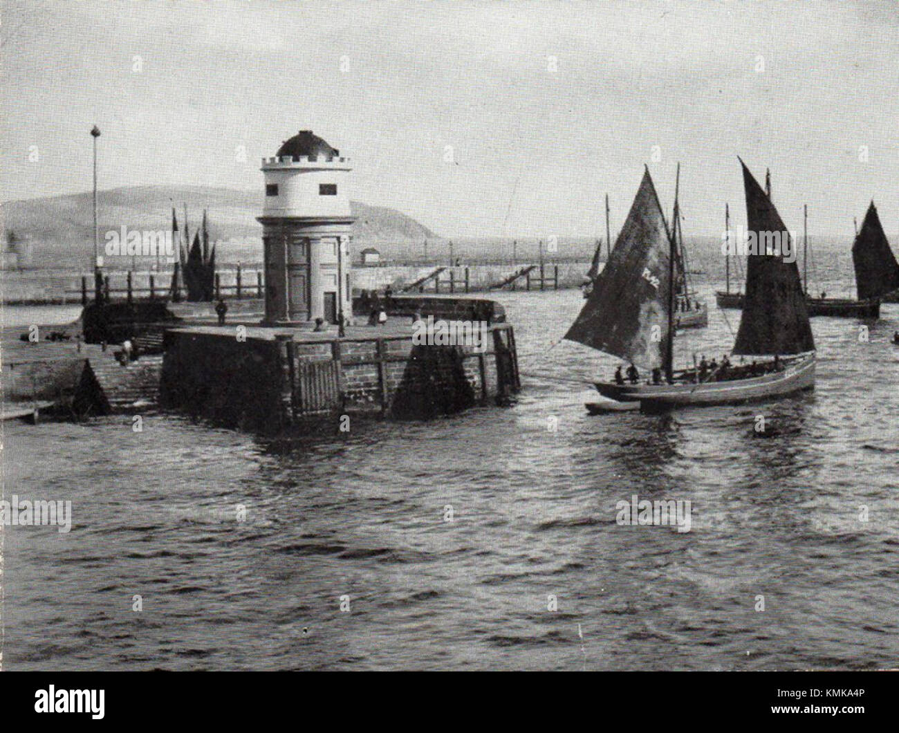 The Red Pier Lighthouse is located at the entrance to a harbor, serving ...