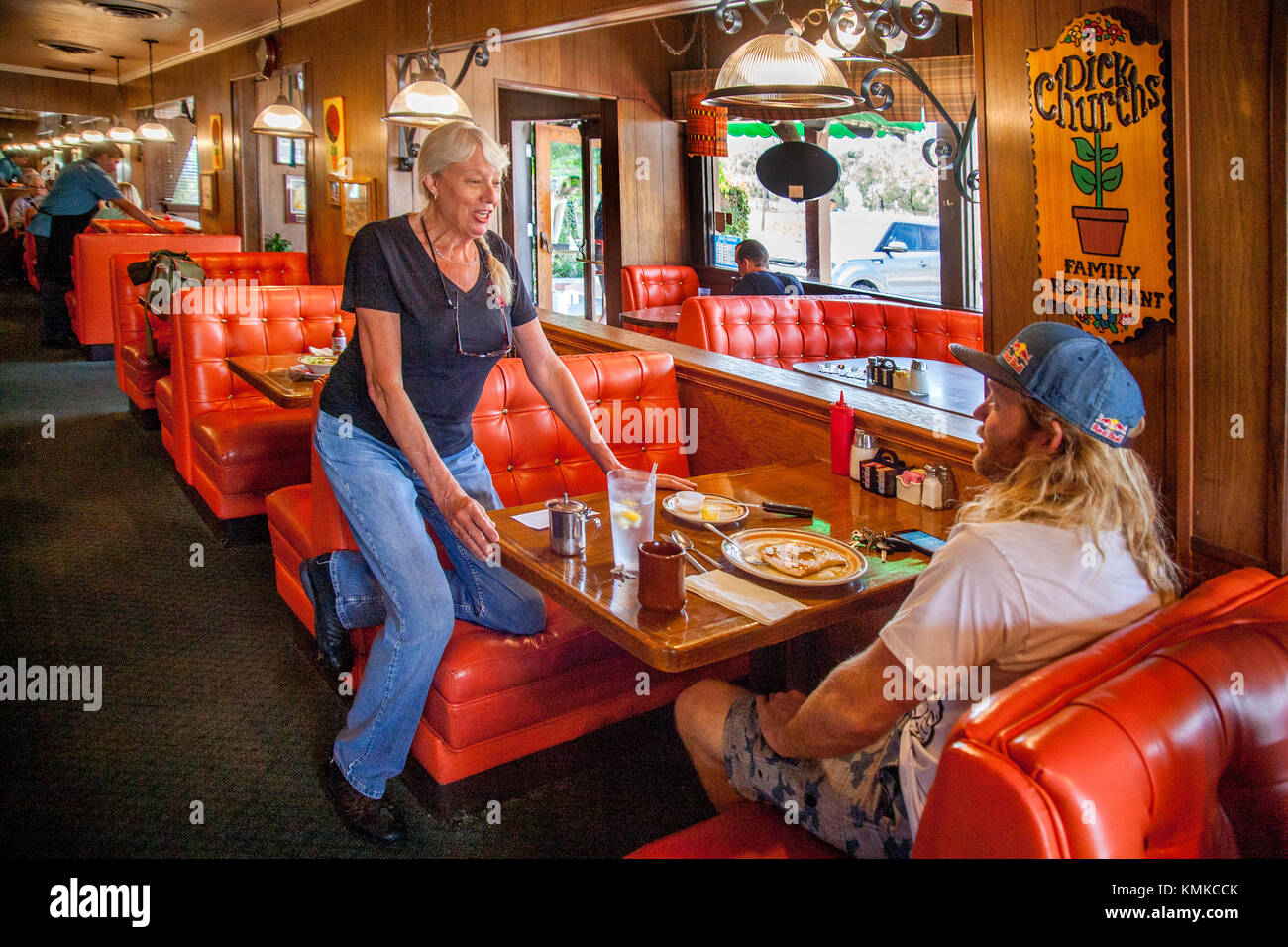 The friendly hostess of a Costa Mesa, CA, restaurant chats with a ...