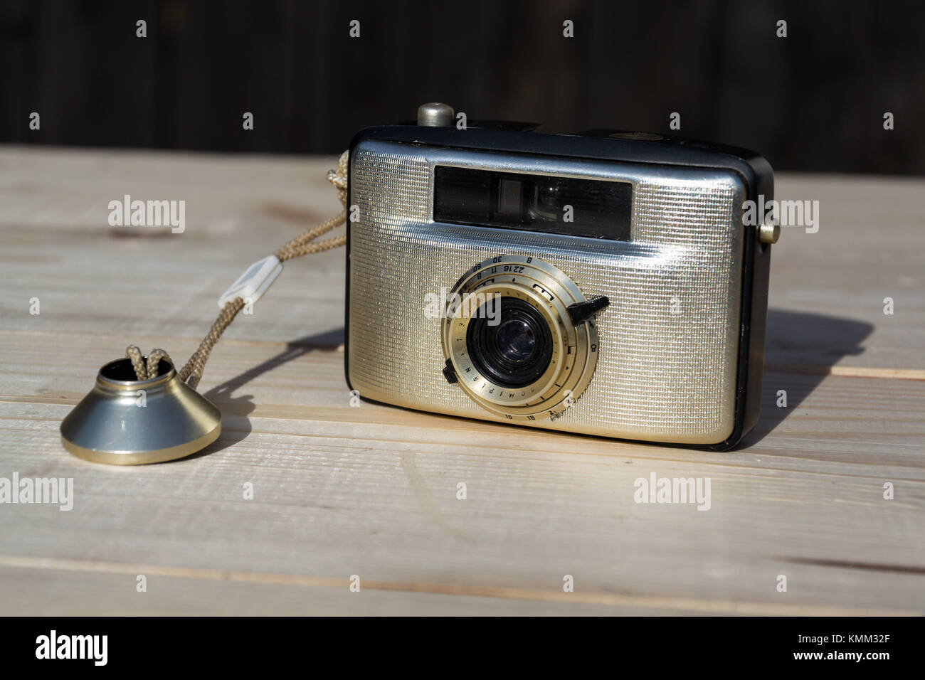 Old vintage golden Penti I camera on wooden background Stock Photo - Alamy