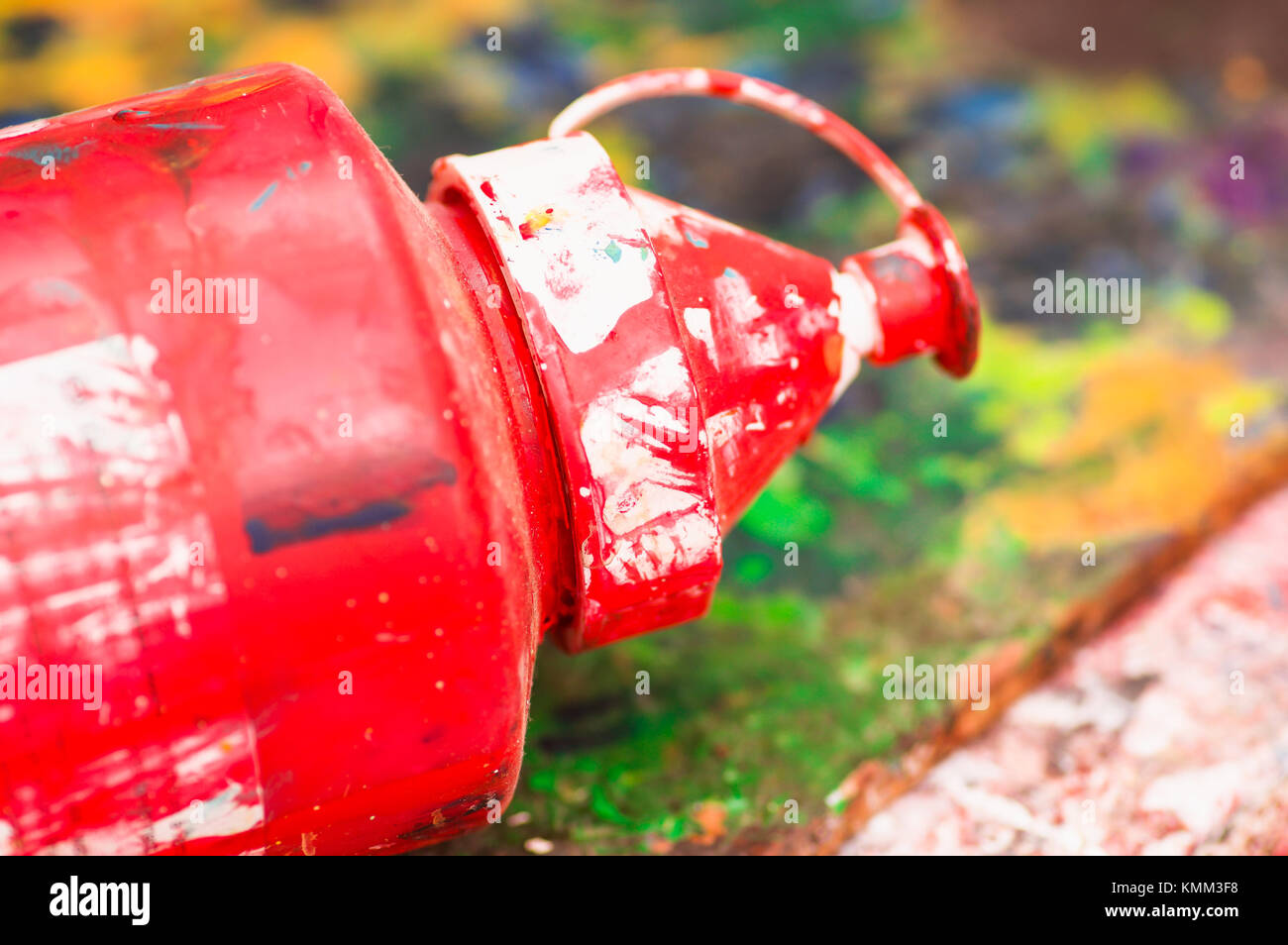 Close up of paint brushes with a red plastic color over a color palette ...