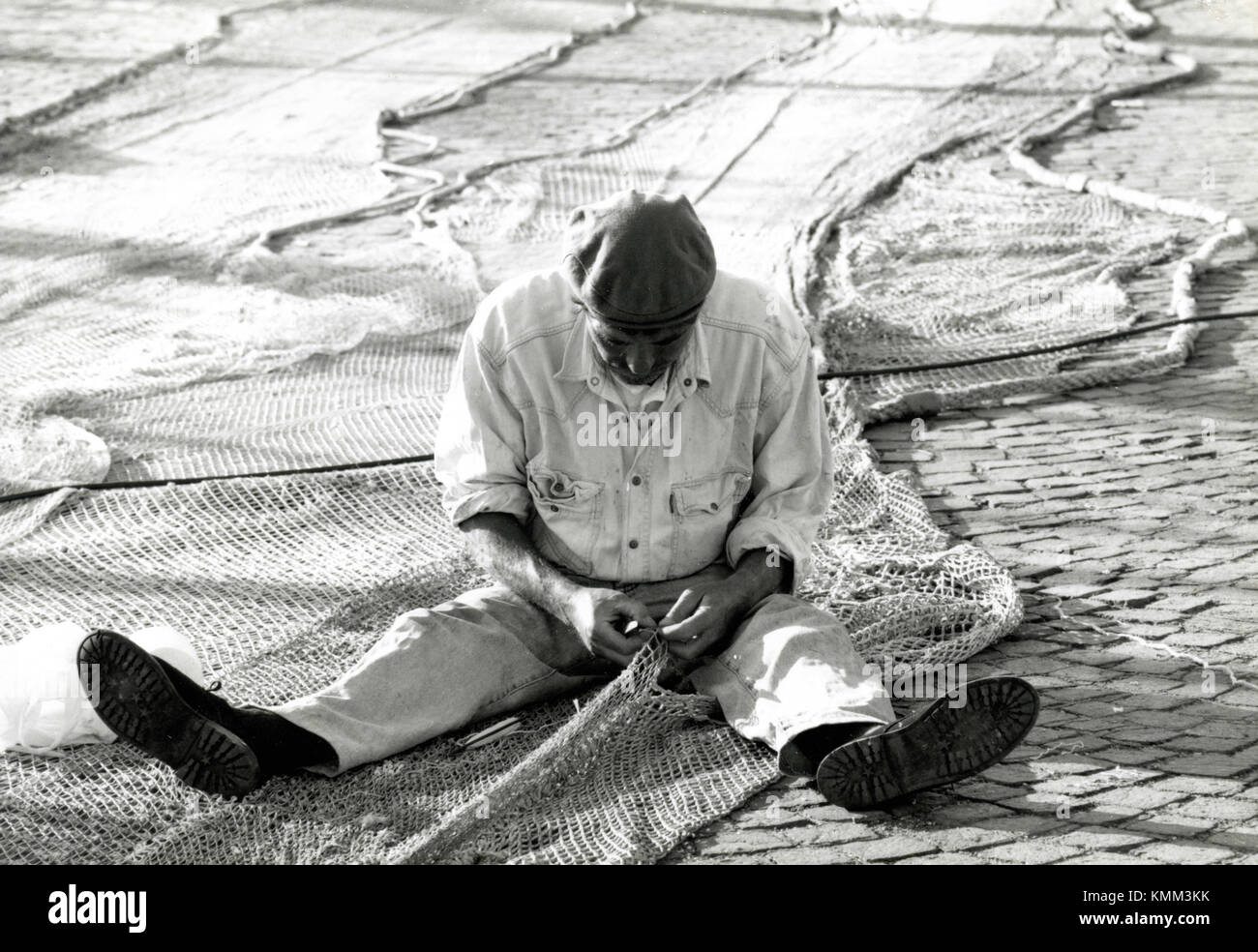 Fisherman mending the nets, Italy 1970s Stock Photo - Alamy