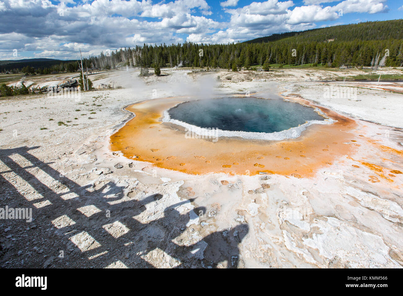 Tourist shadows next to the Crested Pool hot spring at the Yellowstone ...