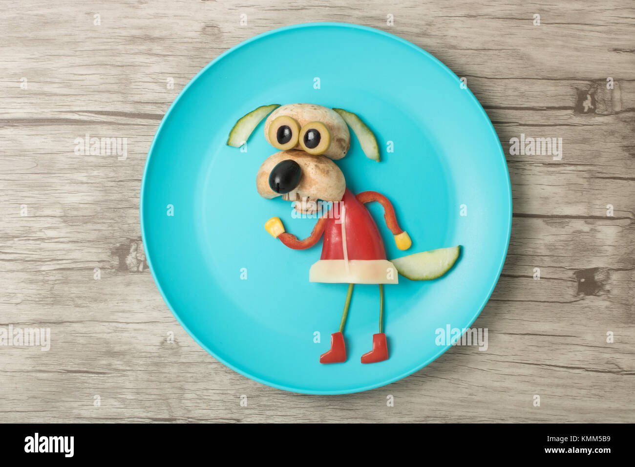 Funny vegetable dog on plate and wood Stock Photo - Alamy