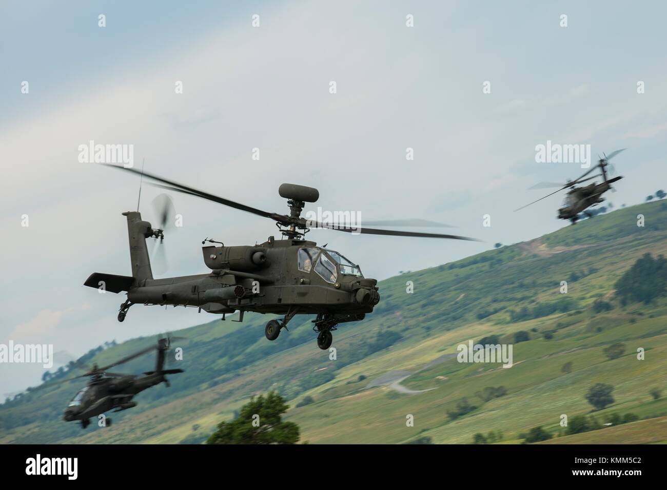 U.S. Army AH-64 Apache helicopters fly during a live fire exercise for ...