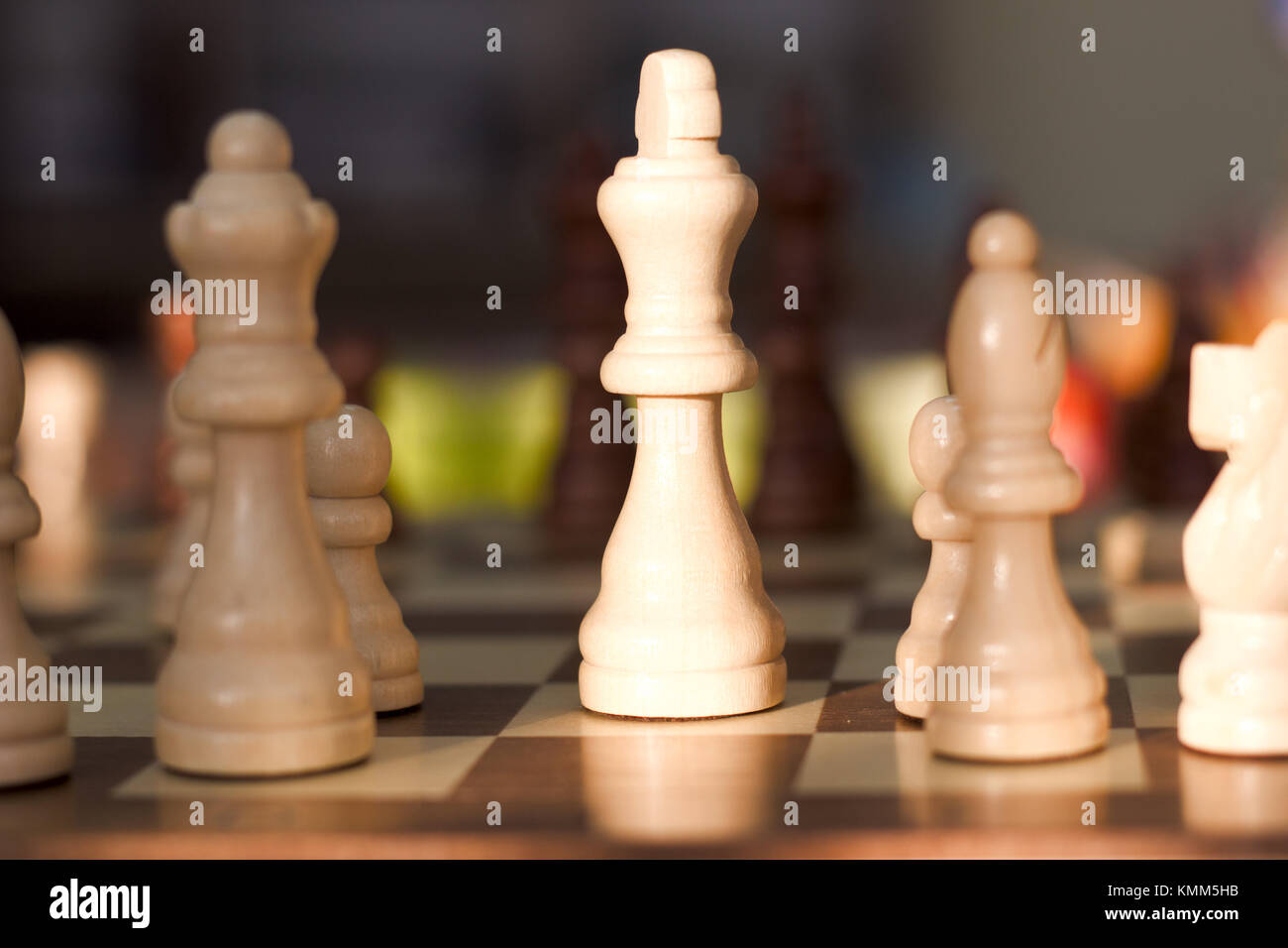 White chess quenn stands out against the background on a chess board ...