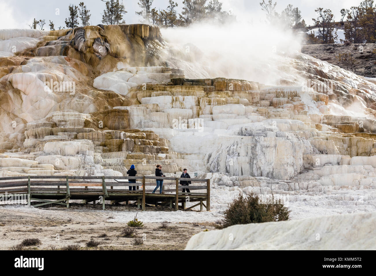 Tourists view the travertine rock formations from the boardwalk at ...
