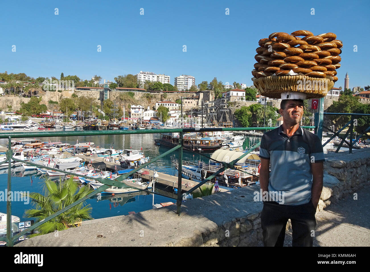 Turkish man poises simits on head, simit is similar to a bagel, covered ...