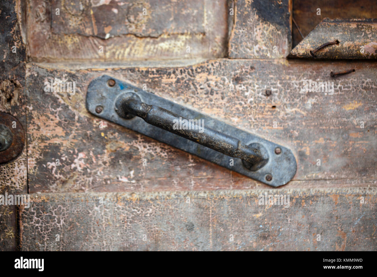 Detail of a rusty metal handle on an old wooden door Stock Photo - Alamy